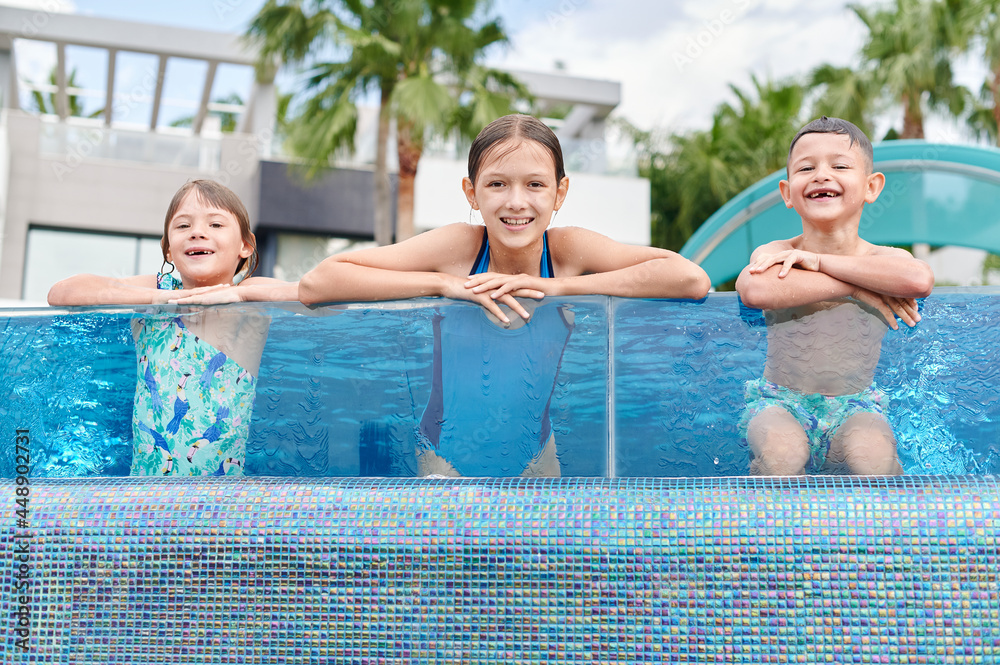 Little children smiling in a swimming pool Stock Photo | Adobe Stock