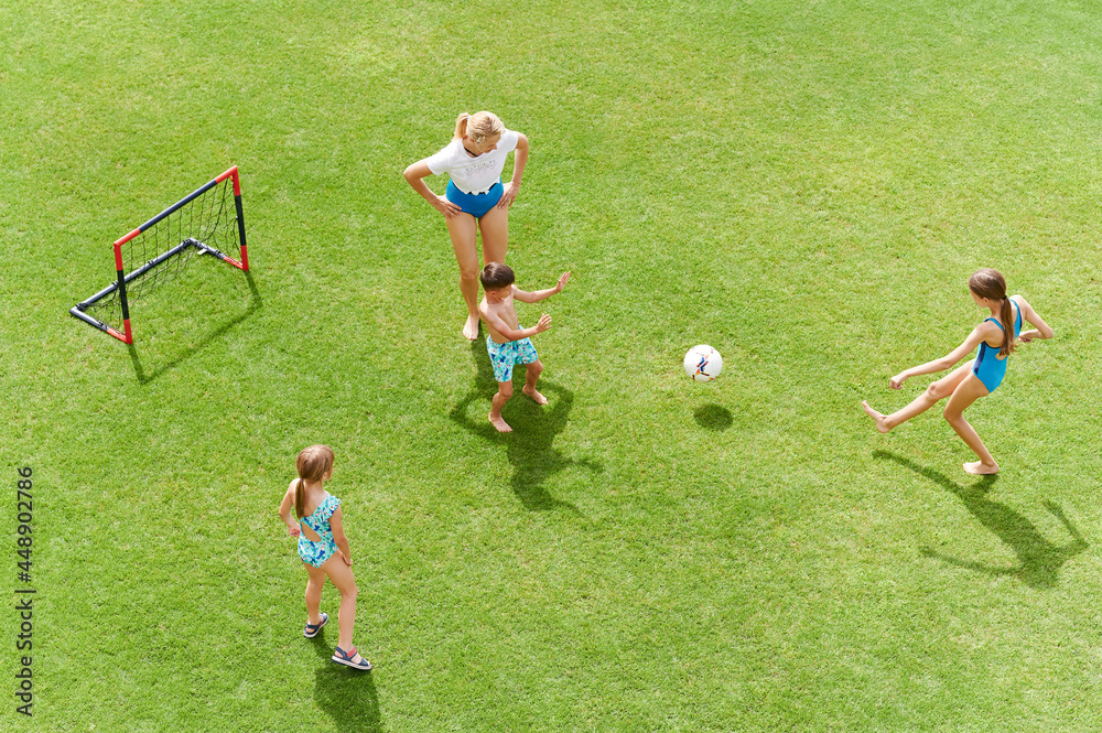 Mom and kids playing soccer outside Stock Photo | Adobe Stock