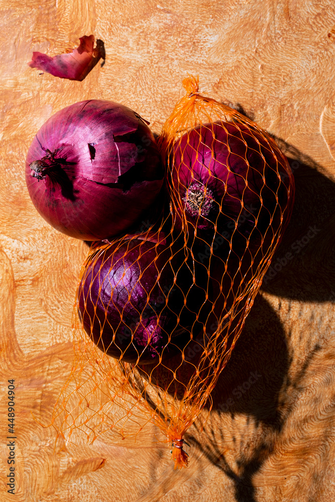 Onions in plastic netting Stock Photo | Adobe Stock