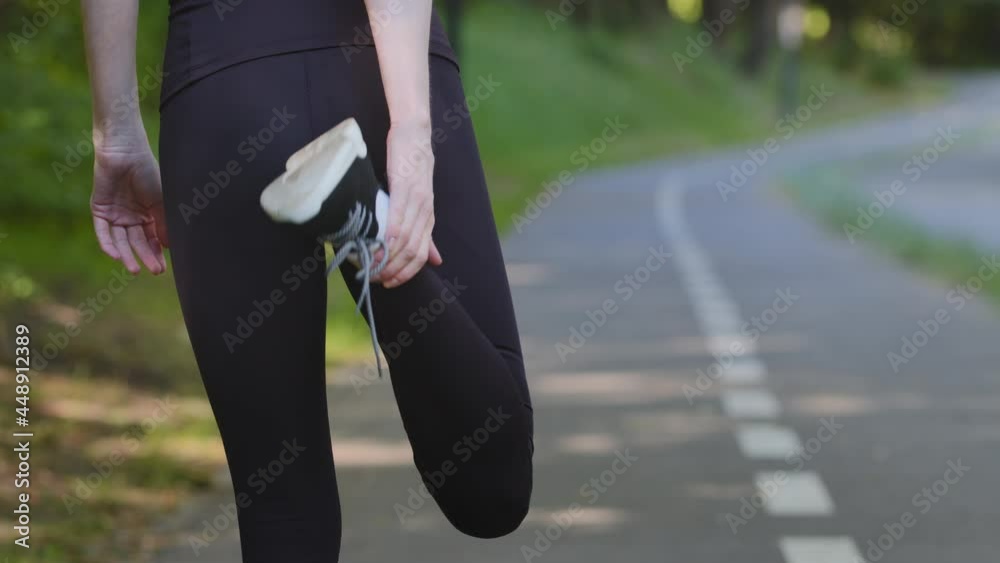 Close-up Female feet on jogging track getting ready to jog. Slim sporty ...