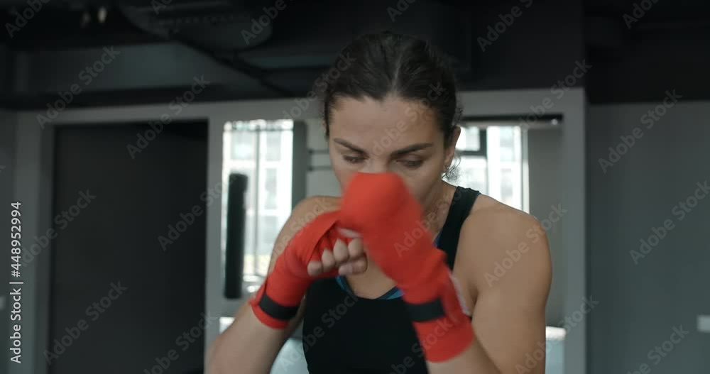 Mixed martial art fighter woman does shadow boxing to the camera in the ...