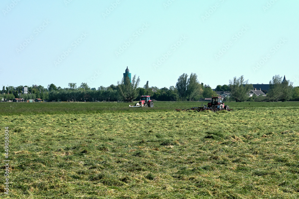 Leerdam, the Netherlands June1,2021:Grassland with tractor mower and ...