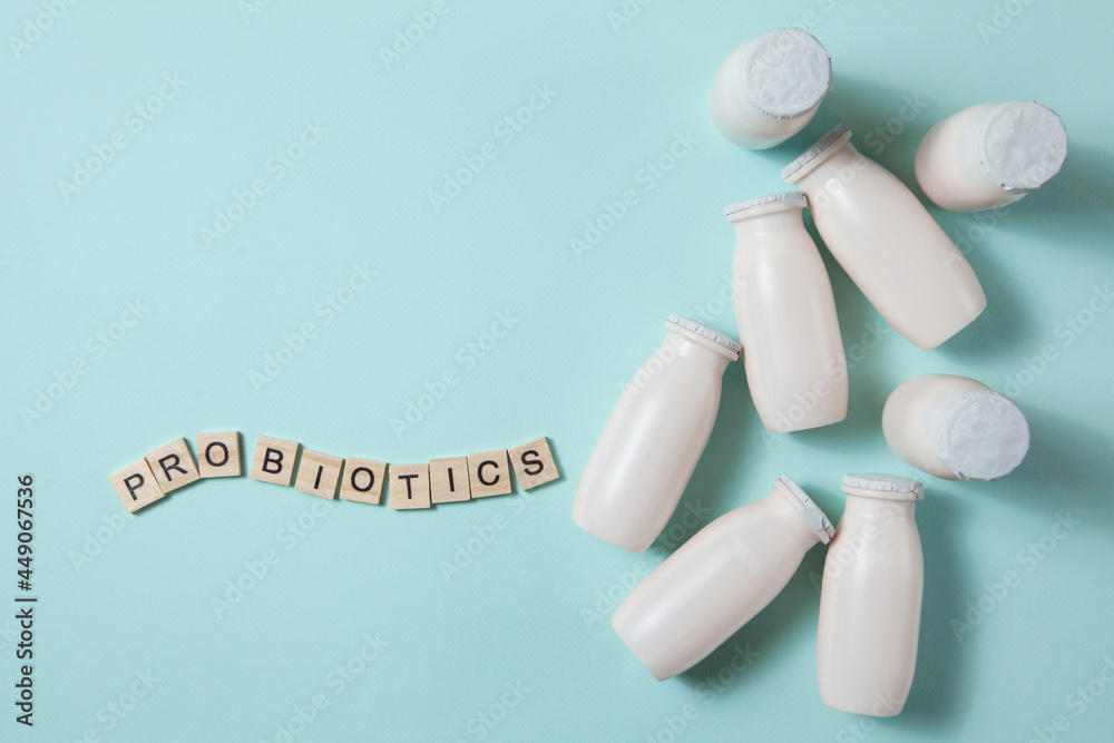 Bottles with probiotics and prebiotics dairy drink on light blue ...