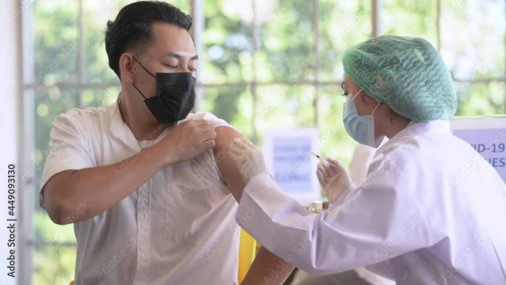 Young asian man patient giving his arm to nurse for injection ...