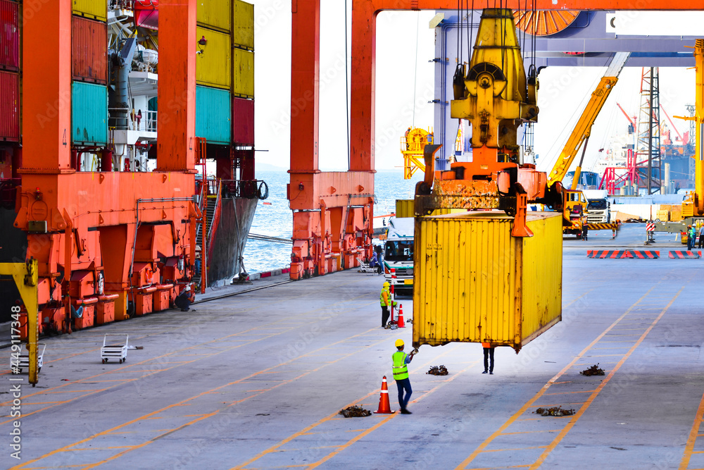 Seaport operation, stevedore removes container twist lock from ...