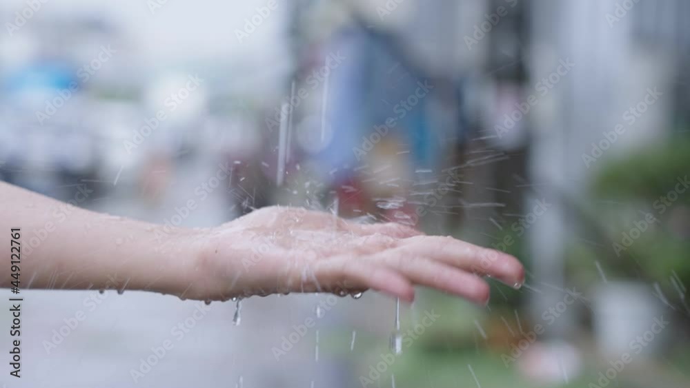 girl hand catches rain drops, touch the season, rains on female Palm ...