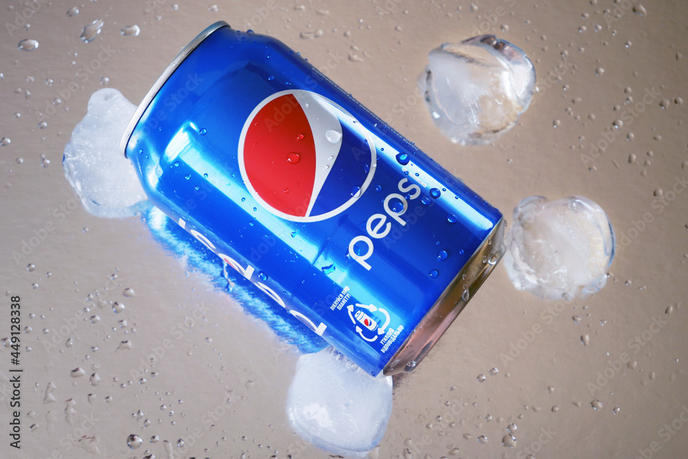 Pepsi Can. and ice pieces carbonated soft drink produced and ...