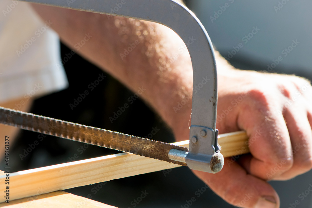 Hand saw with hardened teeth isolated. saw in hand, hacksaw at work ...