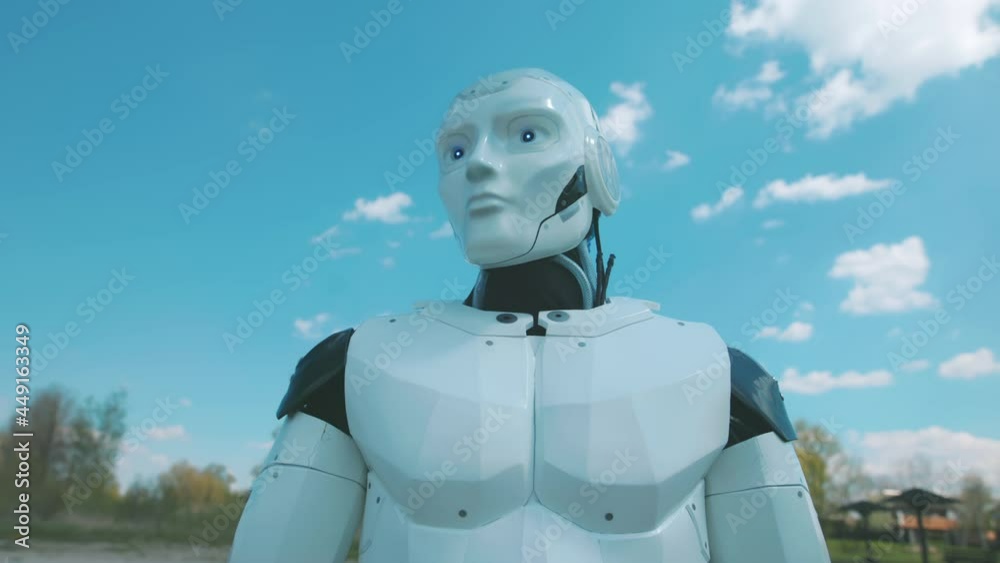 Humanoid AI white robotic prototype cyborg against blue skyline ...