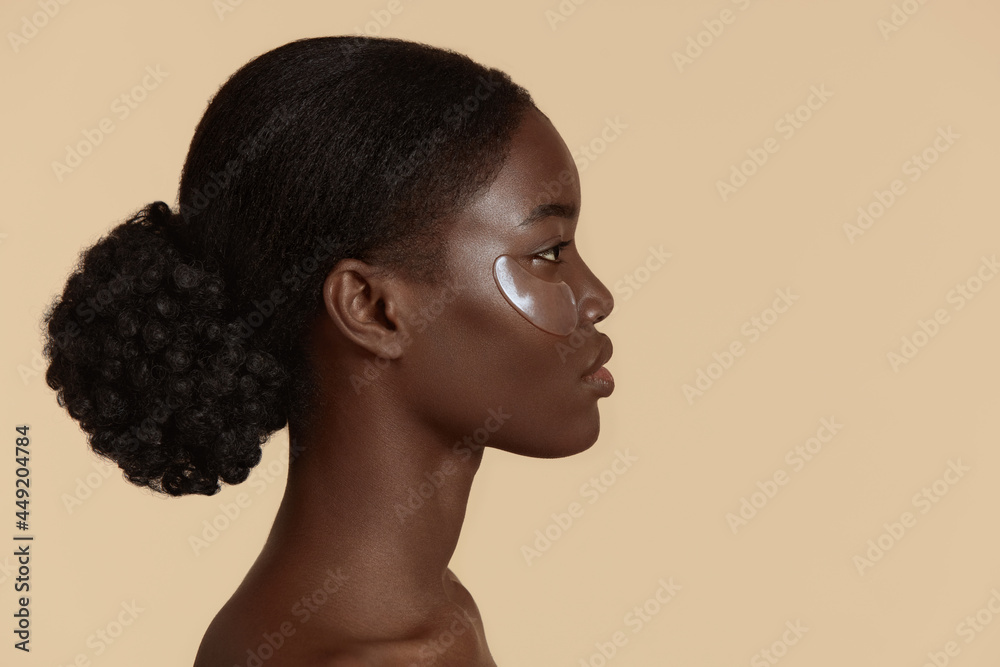 Close up of beautiful african girl with under eye patch on face ...