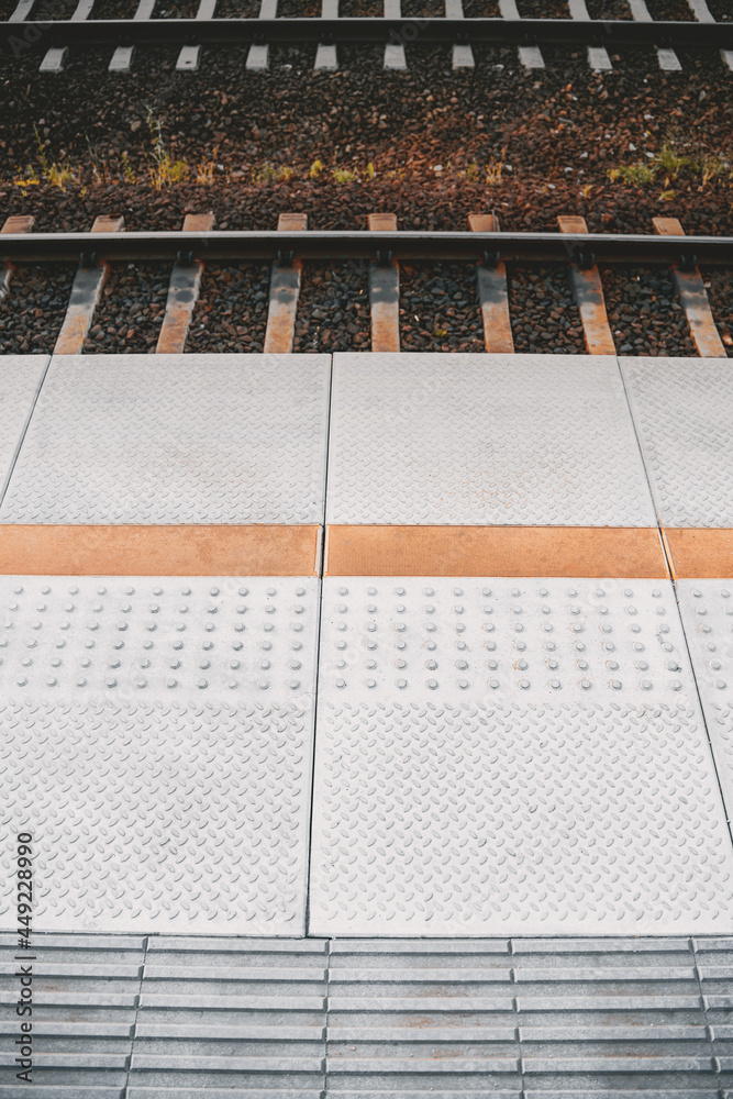 Train platform with tactile dotted pavement for handicapped people ...