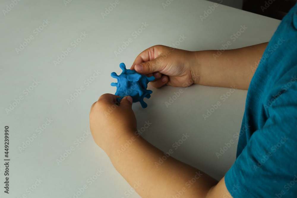 Little boy molding with plastiline coronavirus. Covid-19 virus and kids ...