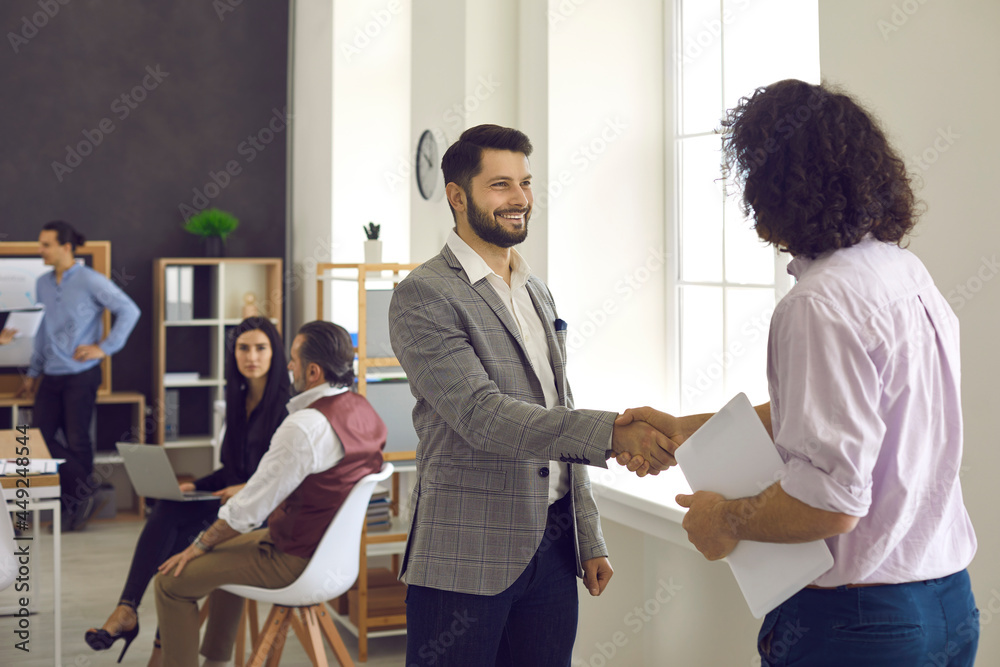 People exchanging a handshake confirming collaboration, greeting each ...