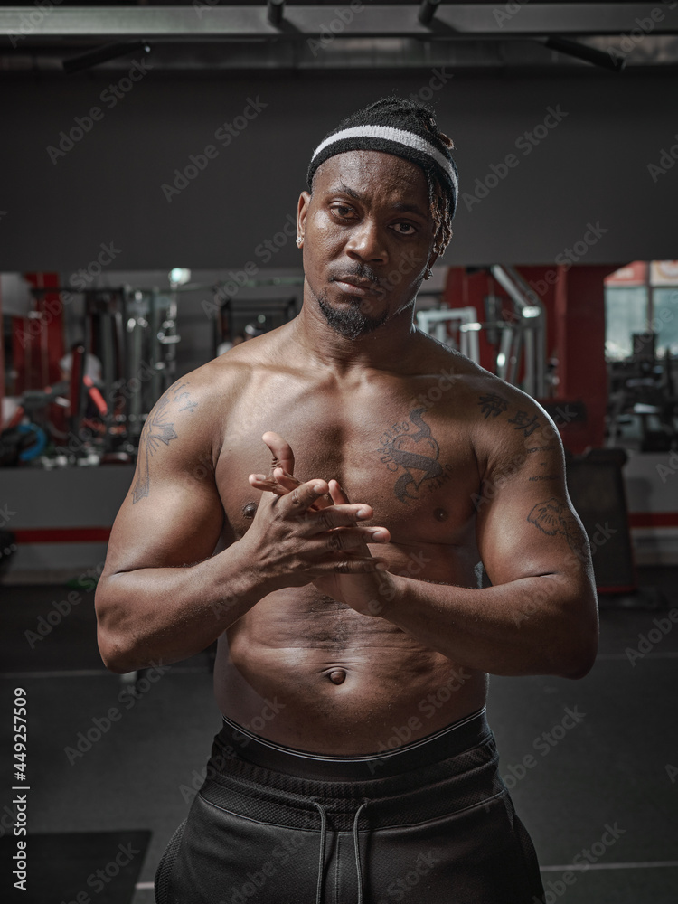 Sports African American Guy With Naked Muscular Torso Standing In Gym