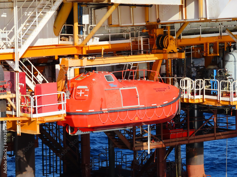 Offshore Life boat or survival craft at muster station of oil and gas ...