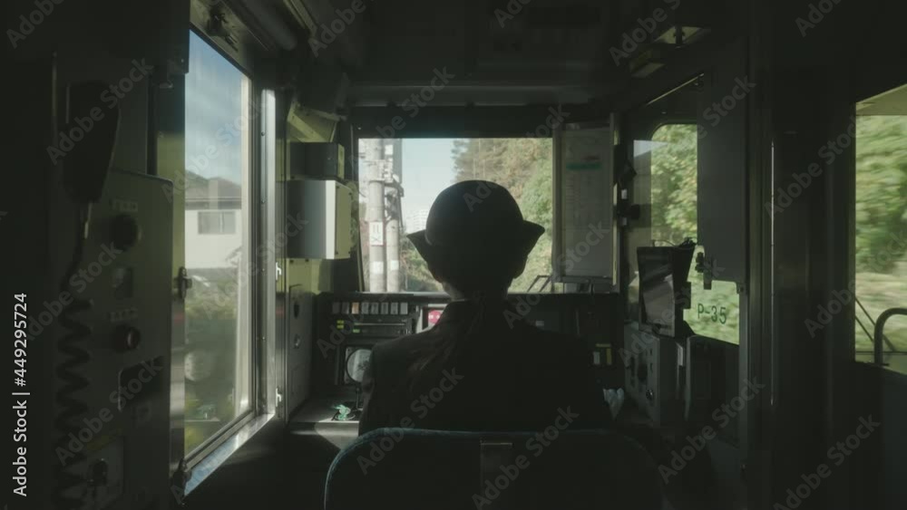 Back View Of A Female Conductor At The Train Cockpit Pointing While ...