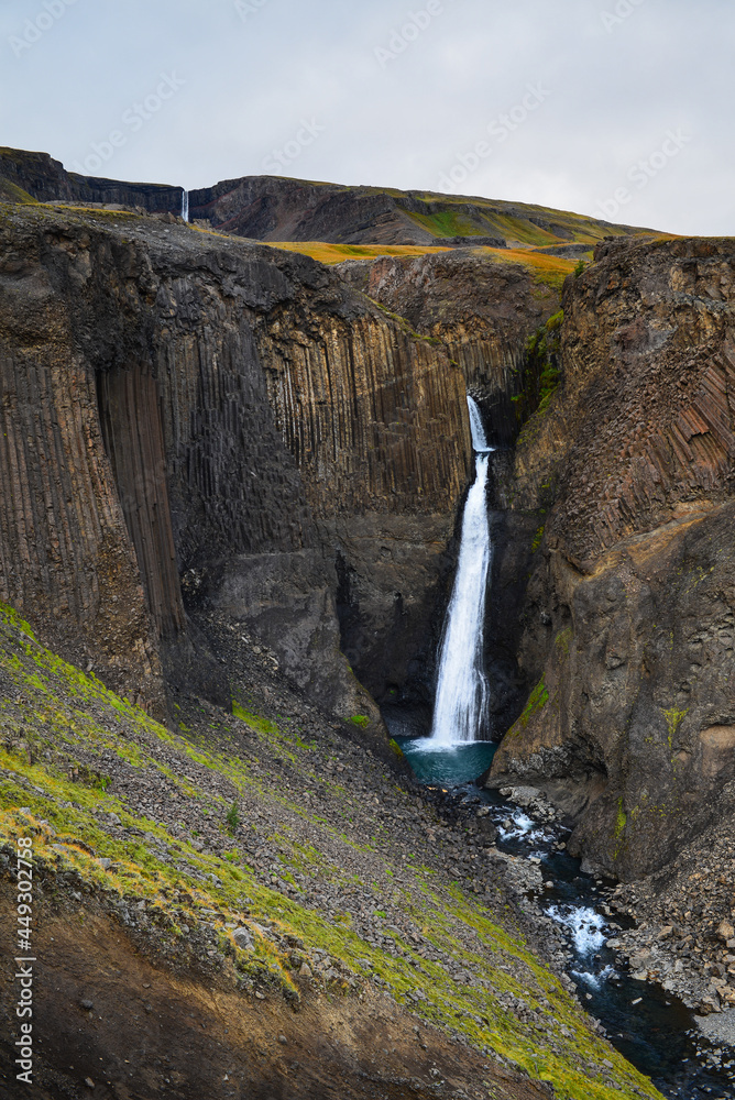 Litlanesfoss waterfall surrounded by basalt columns on the way to ...