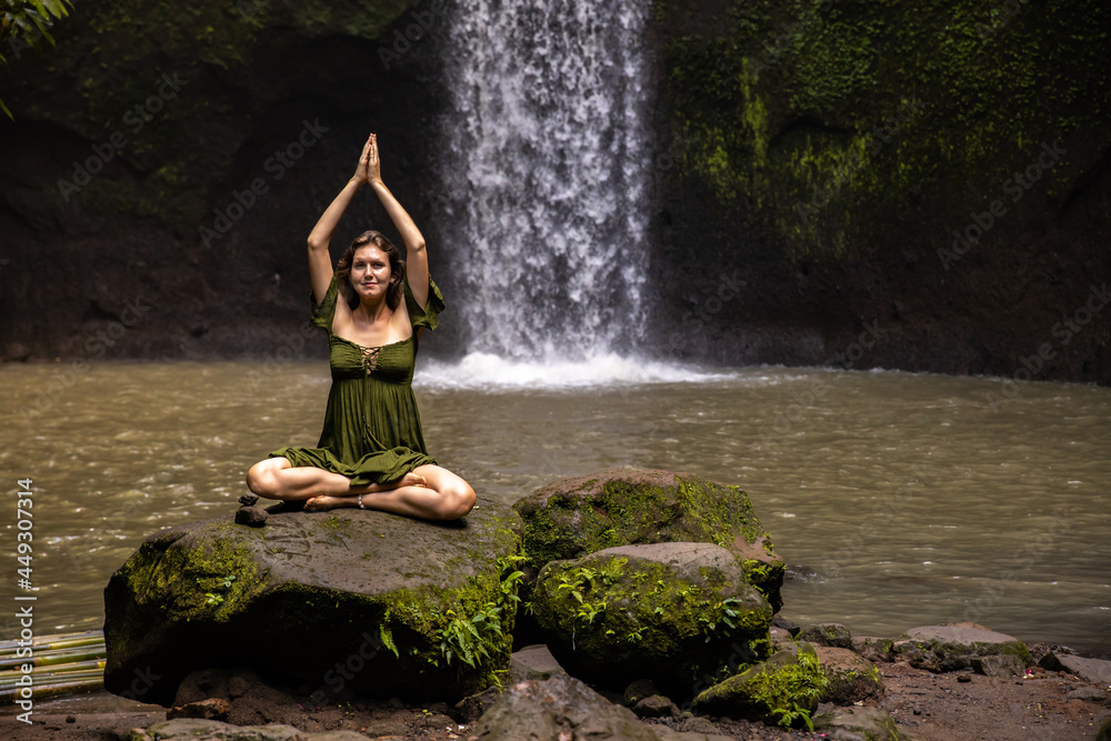 Namaste mudra. Lotus pose. Caucasian woman sitting on the stone ...