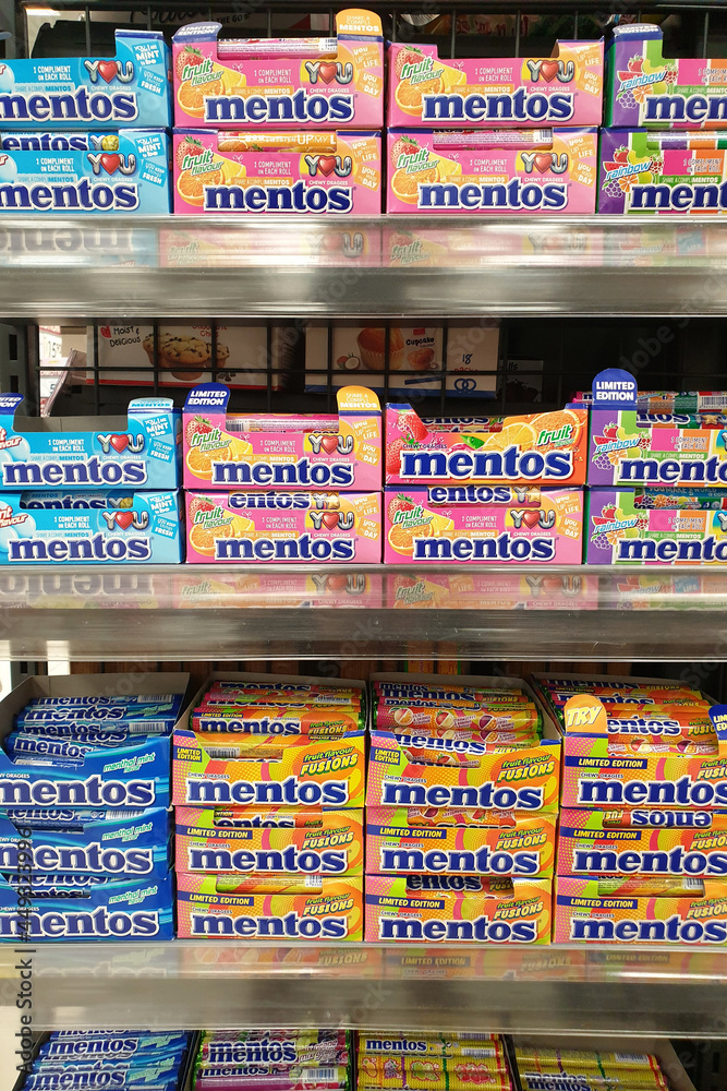 Various choices Mentos brand candy and gum display on the store shelf ...