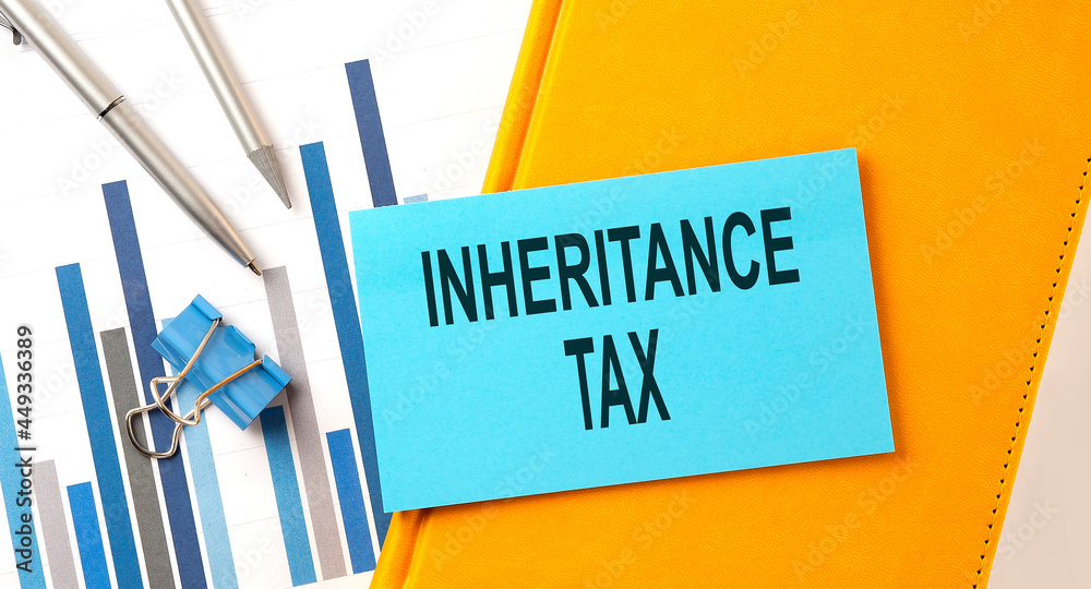 INHERITANCE TAX text on sticker on the yellow notebook with chart and ...