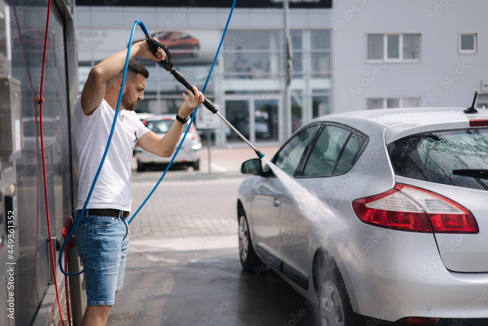 Process of man washing his car in a self-service car wash station Stock ...