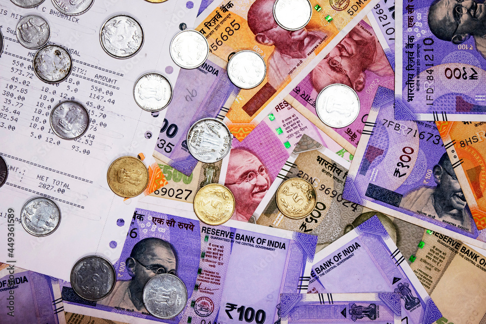 Indian one hundred rupees banknote and coin with a financial bill as a ...