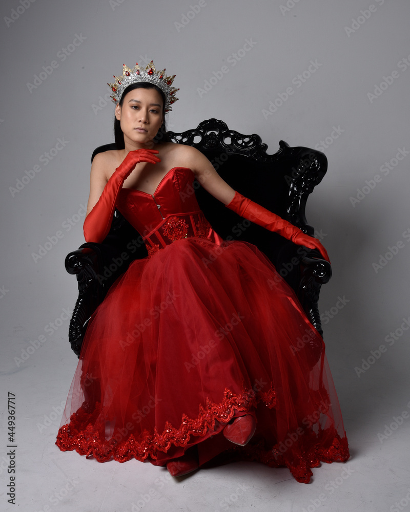 Full length portrait of beautiful young asian woman wearing red corset ...