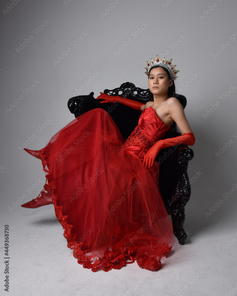 Full length portrait of beautiful young asian woman wearing red corset ...
