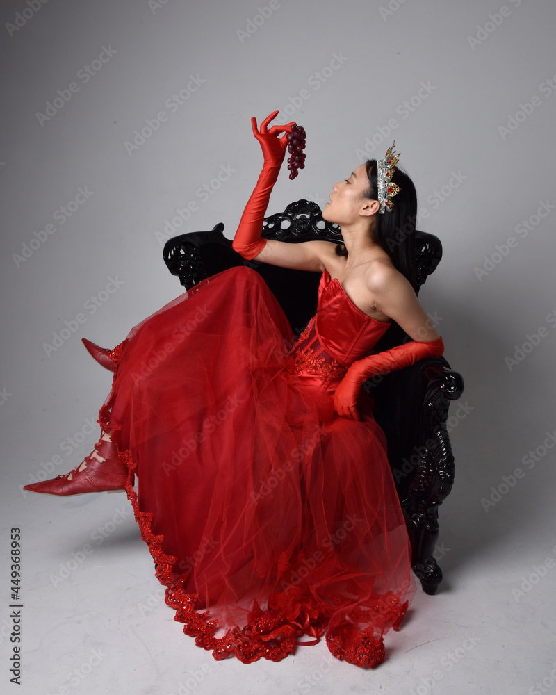 Full length portrait of beautiful young asian woman wearing red corset ...