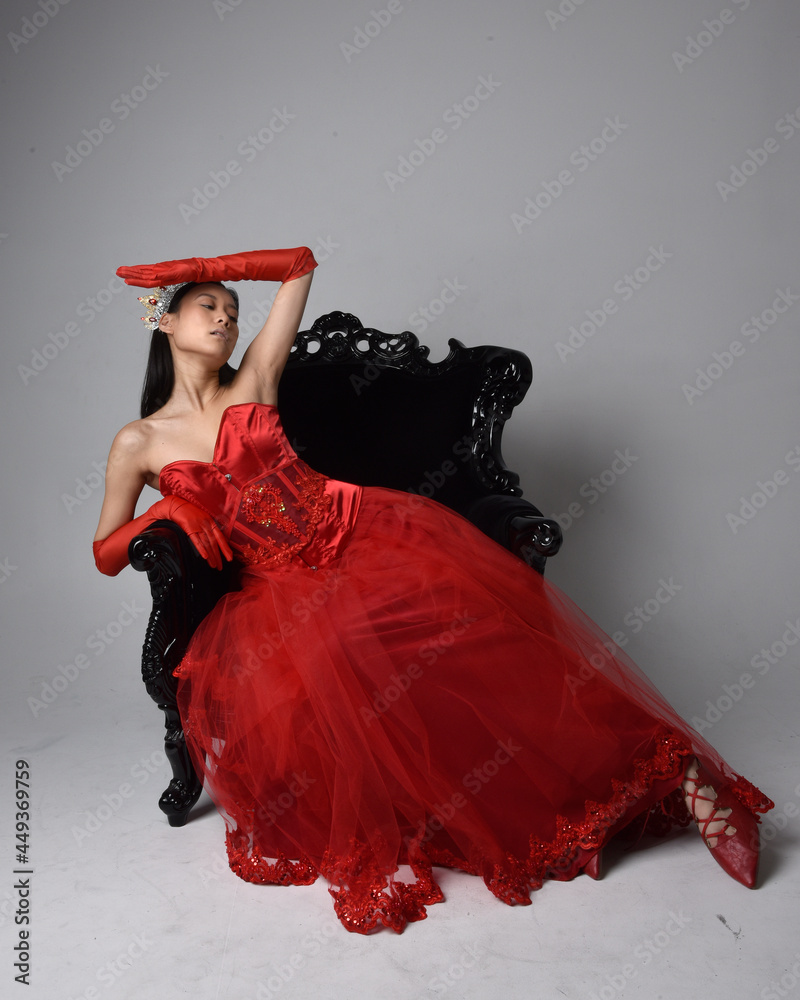 Full length portrait of beautiful young asian woman wearing red corset ...