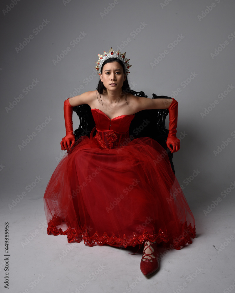 Full length portrait of beautiful young asian woman wearing red corset ...