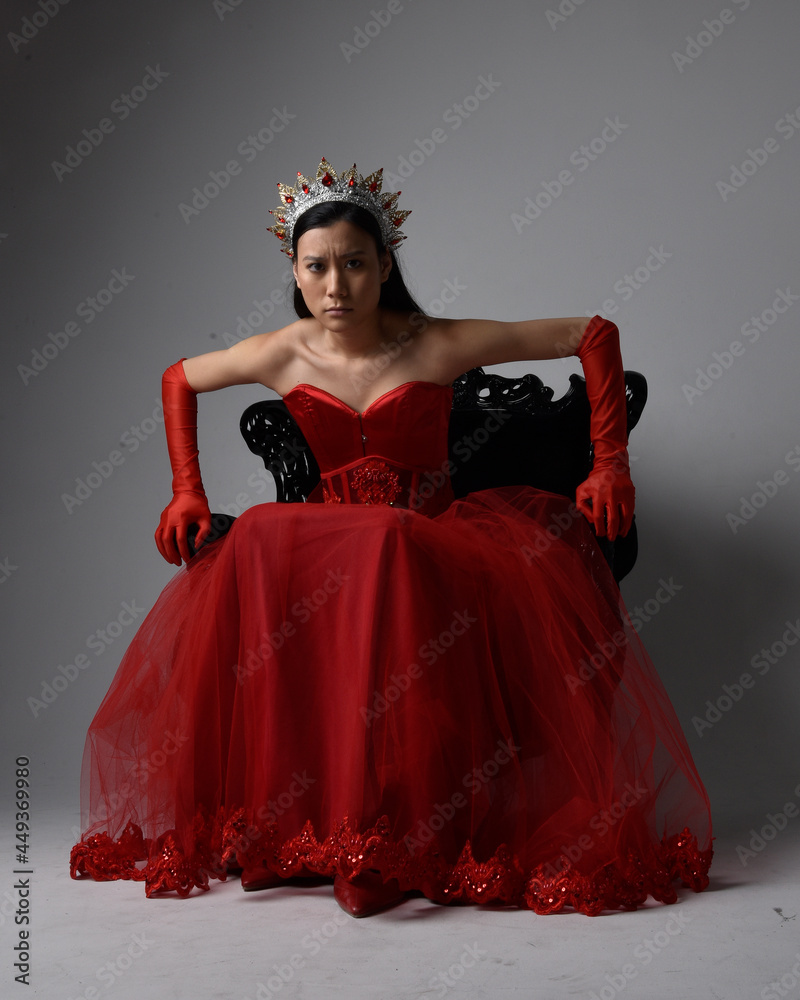 Full length portrait of beautiful young asian woman wearing red corset ...