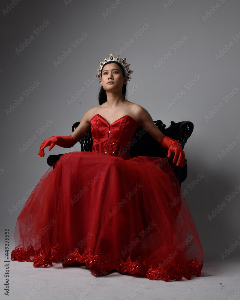 Full length portrait of beautiful young asian woman wearing red corset ...