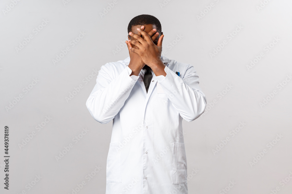 Annoyed, pissed-off african-american male doctor trying avoid annoying ...