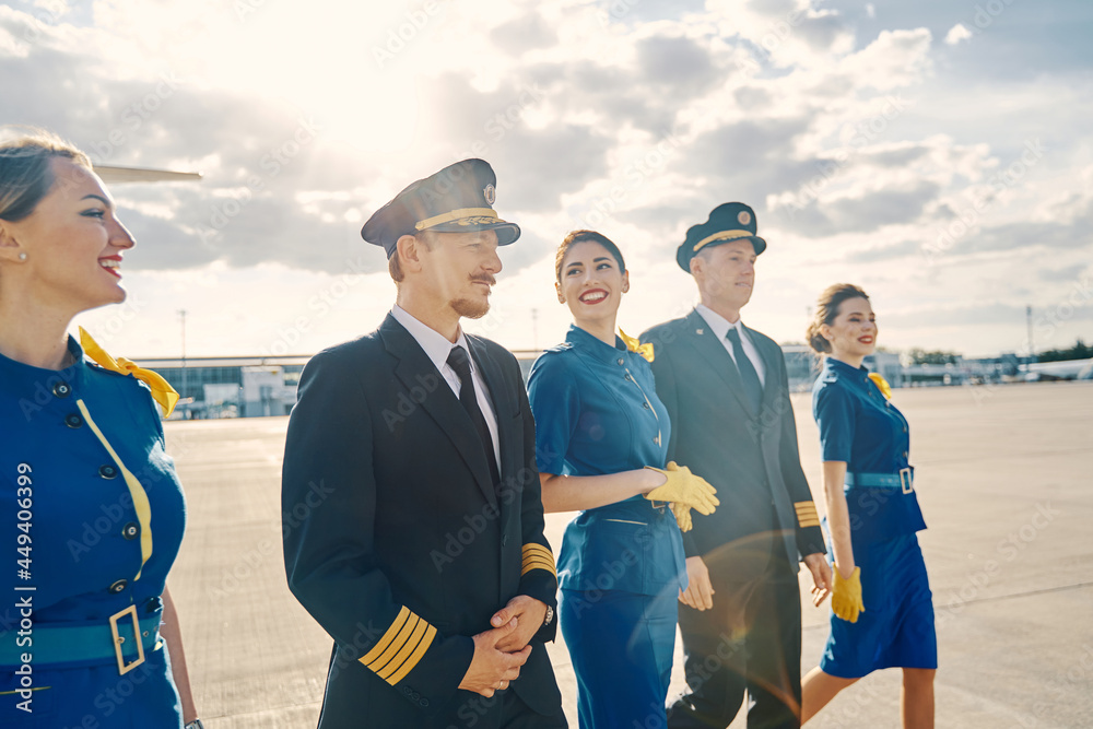Happy female flight attendants and airline pilots going ahead Stock ...