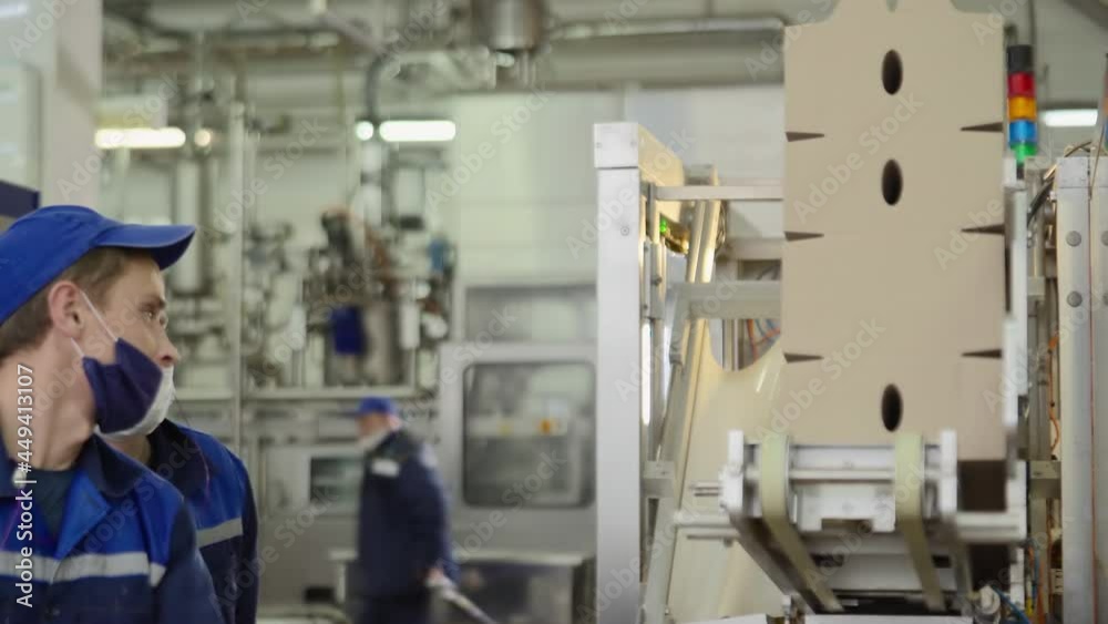 Workers At Packaging Line Stack Cardboard Boxes At Modern Production ...