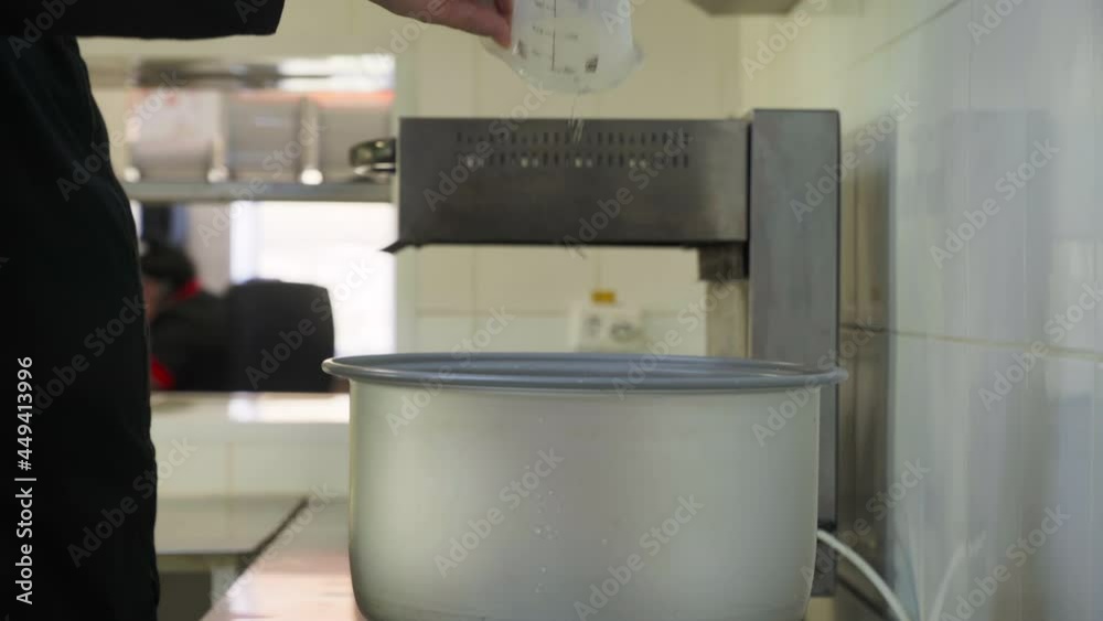 Cook Pouring Water Into Pot With Rice For Japanese Dish Cooking At ...