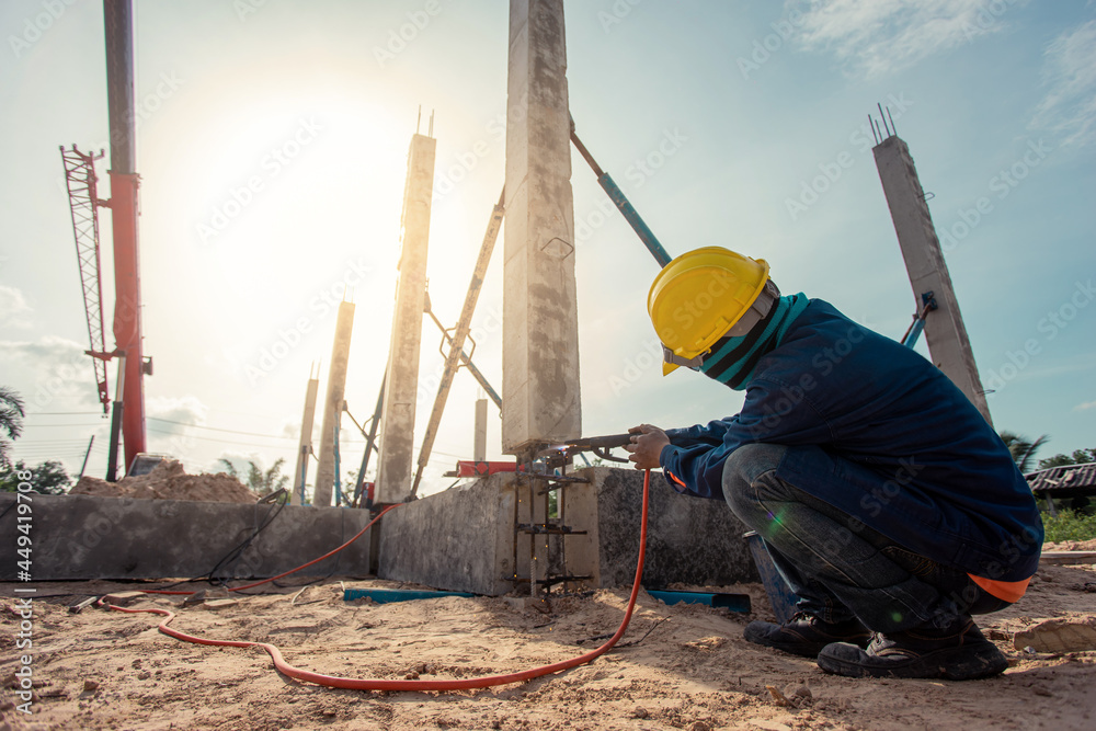Welder working welding assembly structure between ground beam and ...