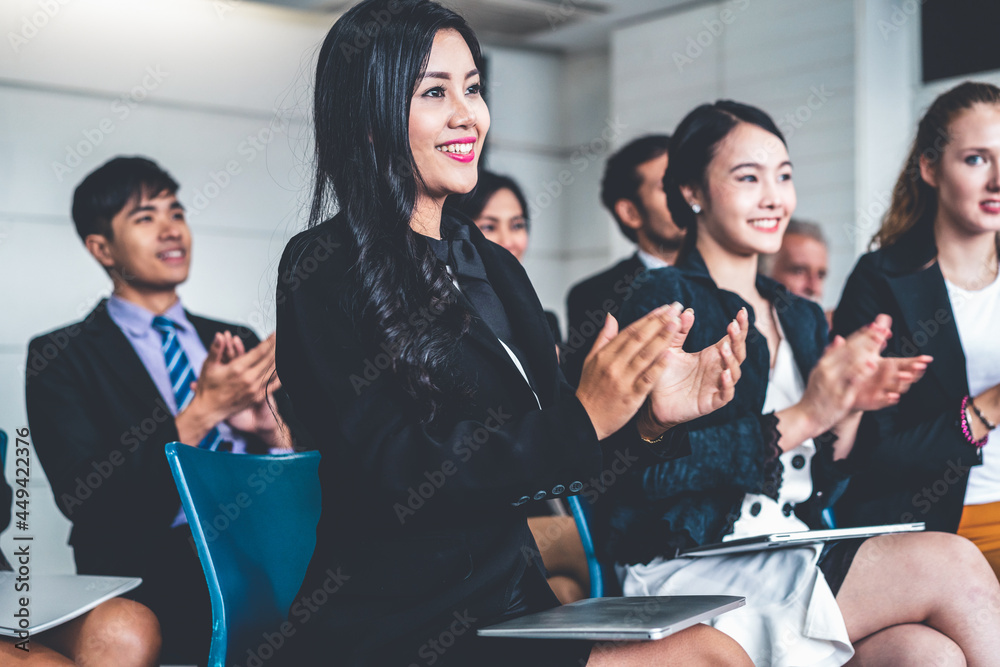 Professional young Asian and Caucasian audience applauding in group ...
