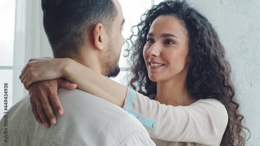 Back view spaniard man husband boyfriend hugs curly brunette woman ...