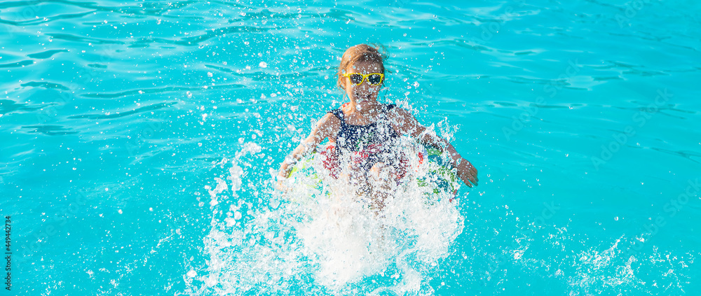 A child in a circle swims in the pool. Selective focus. Stock Photo ...
