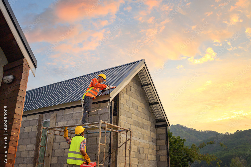 Roofer working on roof structure of building on construction site ...