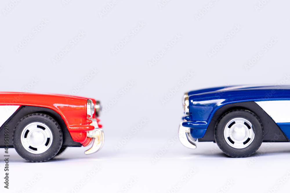 Red and blue cars parked facing each other. On isolated white ...