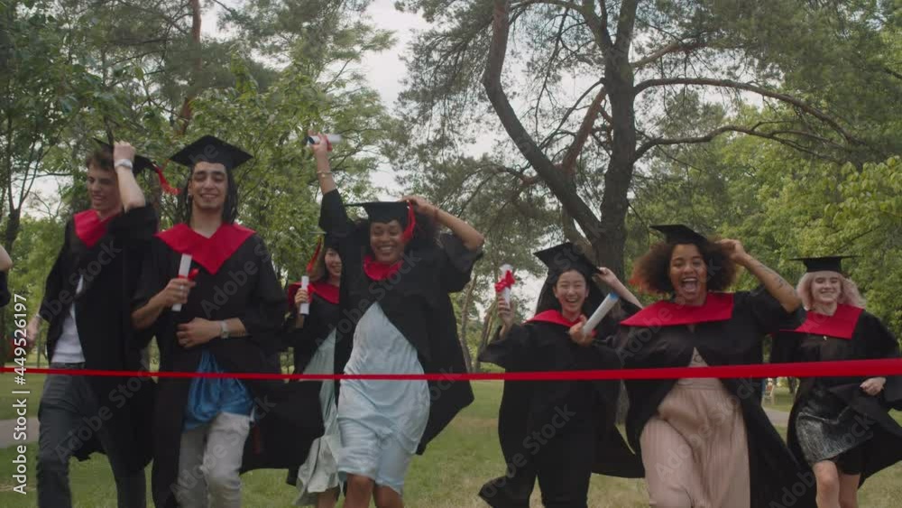 Group of carefree successful diverse multiethnic graduates with ...