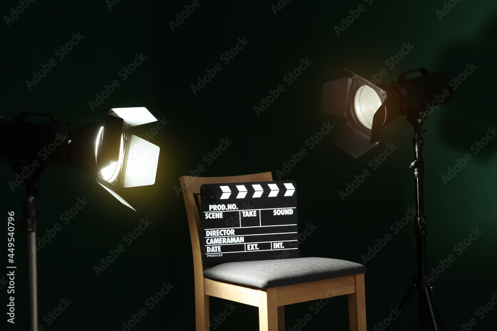 Chair with clapperboard under spotlight in studio Stock Photo | Adobe Stock