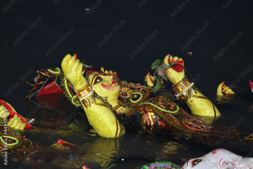 Goddess Durga puja immersion at Ganges river, Kolkata. Shot of floating ...