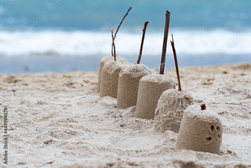 Sand buildings, sand castles on the beach left by children, destroyed ...