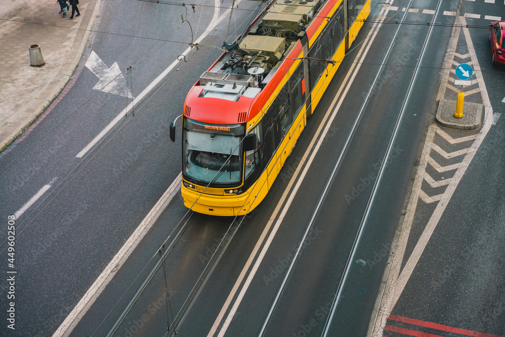 Top view of yellow and red tramway and road in the city. Transportation ...
