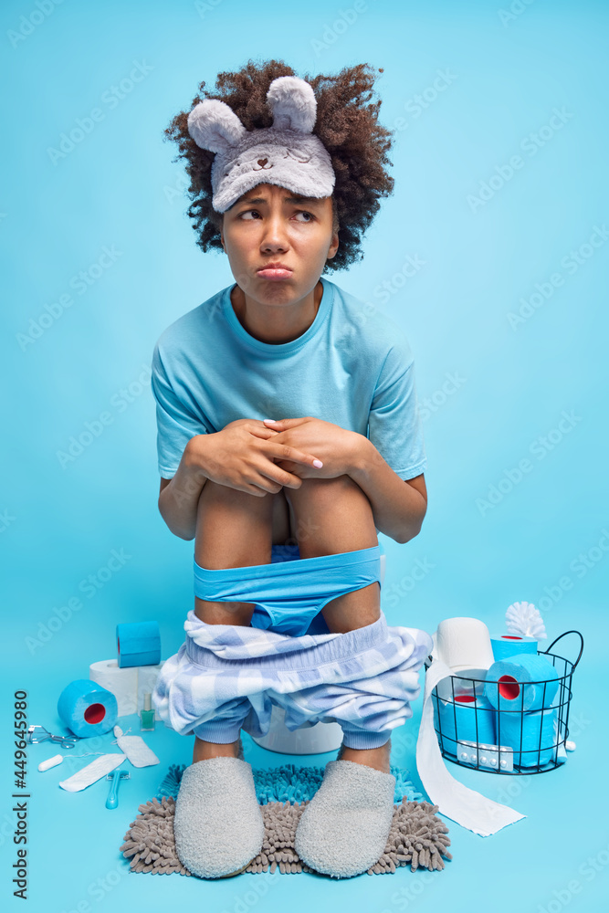 Displeased Afro American woman has dissatisfied expression suffers from ...