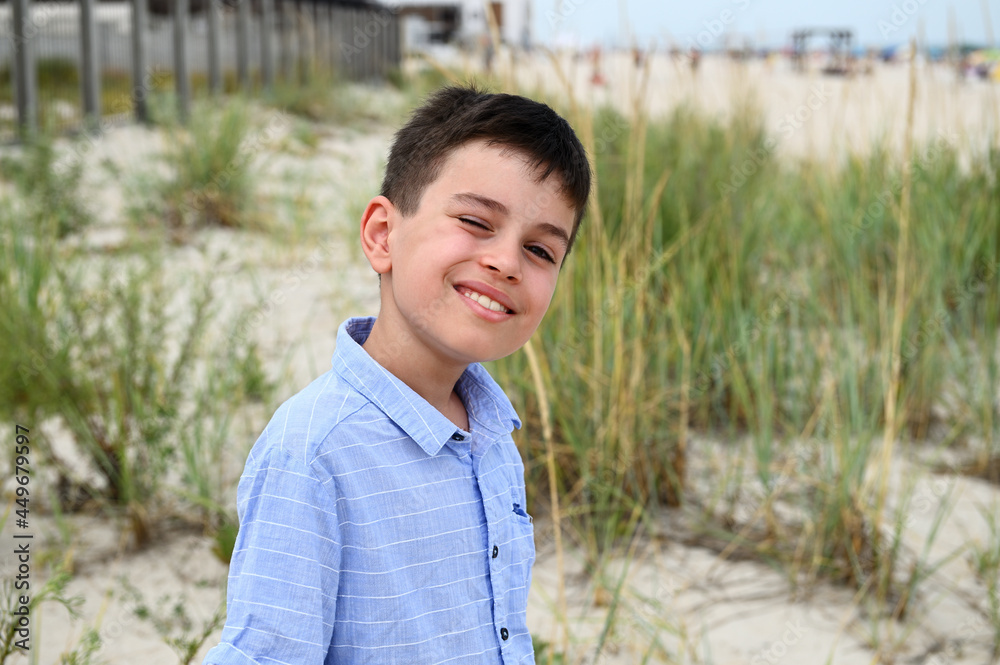 Headshot of adorable kid cute smiling standing against the backdrop of ...